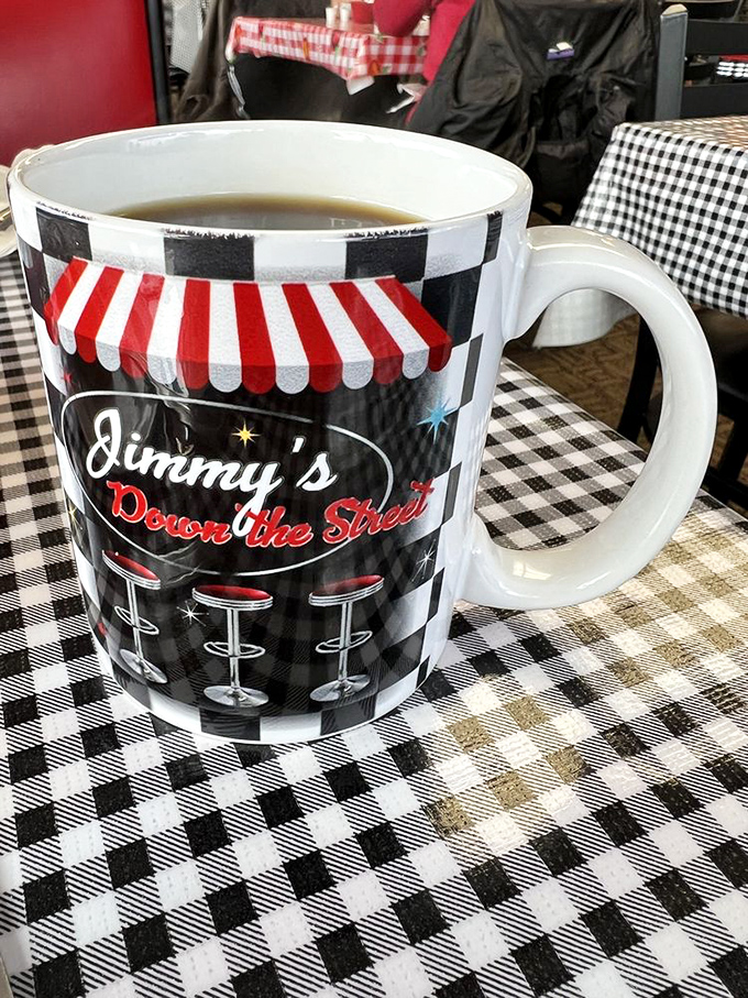 The official mascot of Jimmy's sits proudly on checkered tablecloths. This isn't just coffee—it's liquid motivation in ceramic form.