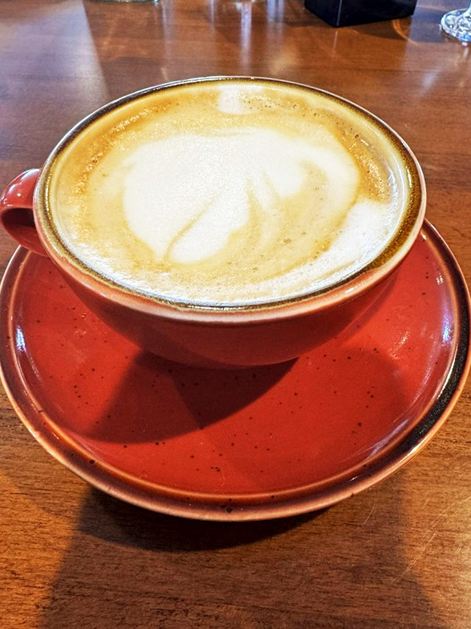 A proper latte in a rustic red cup&mdash;because sometimes the best part of waking up isn't just what's in your cup, but where you're drinking it.