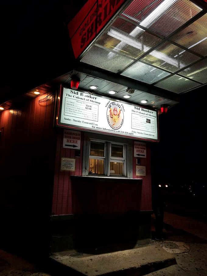 Under the glow of fluorescent lights, this humble window becomes Philadelphia's most honest late-night food embassy, serving diplomacy one shrimp at a time.