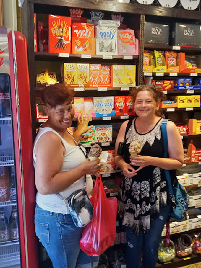 Two happy shoppers experiencing that universal candy store grin&mdash;the one that says, "Diet? What diet? I'm living my best life!"