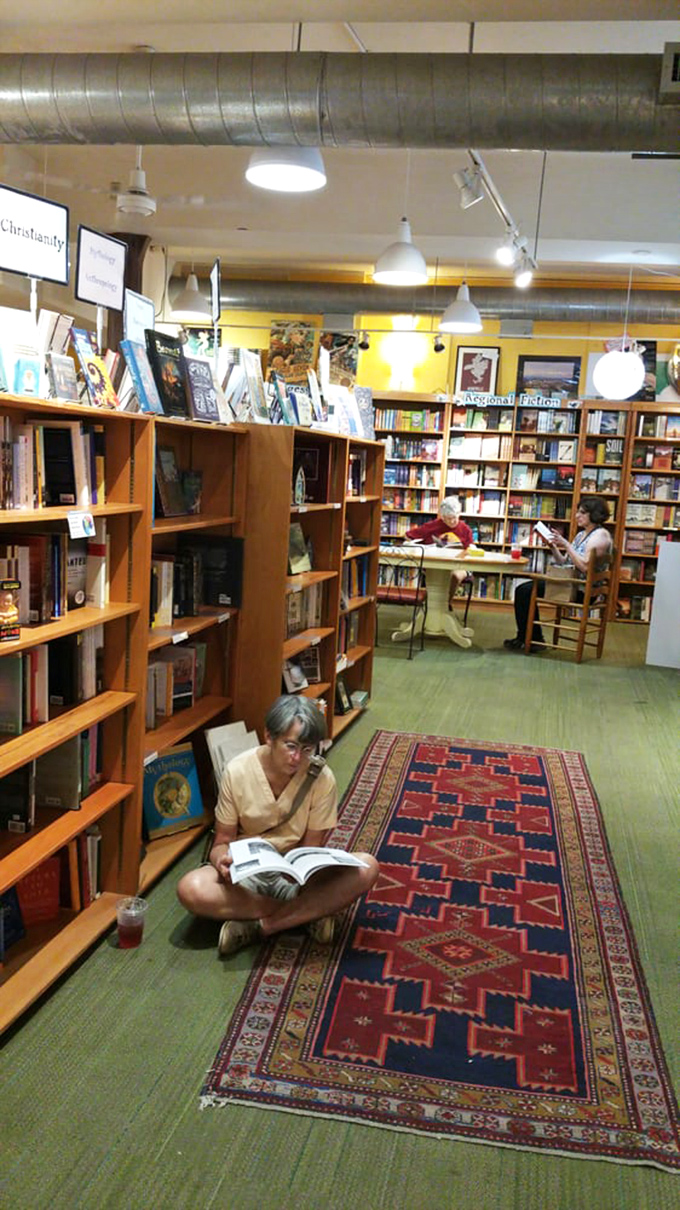 Literary pilgrims finding their sacred space between the stacks. That carpet has absorbed more silent gasps at plot twists than any therapist's couch.