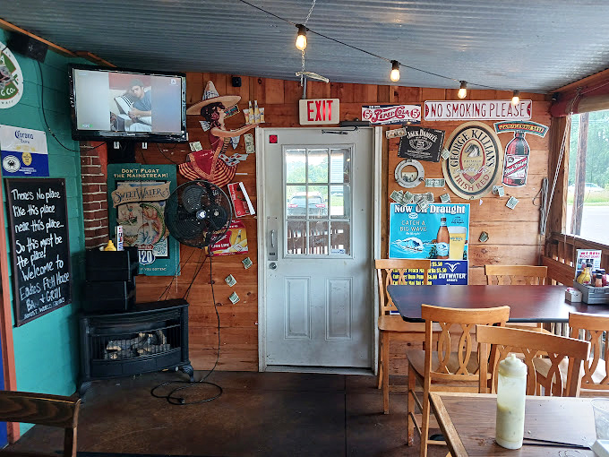 The turquoise walls and beer signs create that "coastal dive bar teleported to Ohio" vibe that somehow makes seafood taste even better.