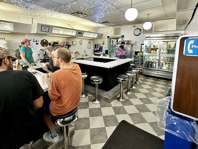 Morning rituals unfold at the counter, where strangers become temporary friends united by the universal language of fried dough.