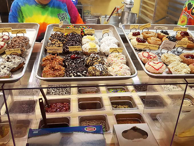 The display case: where diet resolutions go to die and happiness is measured in inches of frosting and sprinkles.