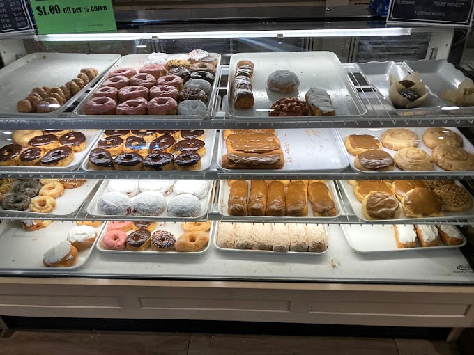 The donut display case: where good intentions go to die and breakfast becomes an all-day possibility. Each ring of fried perfection practically begs for coffee companionship.