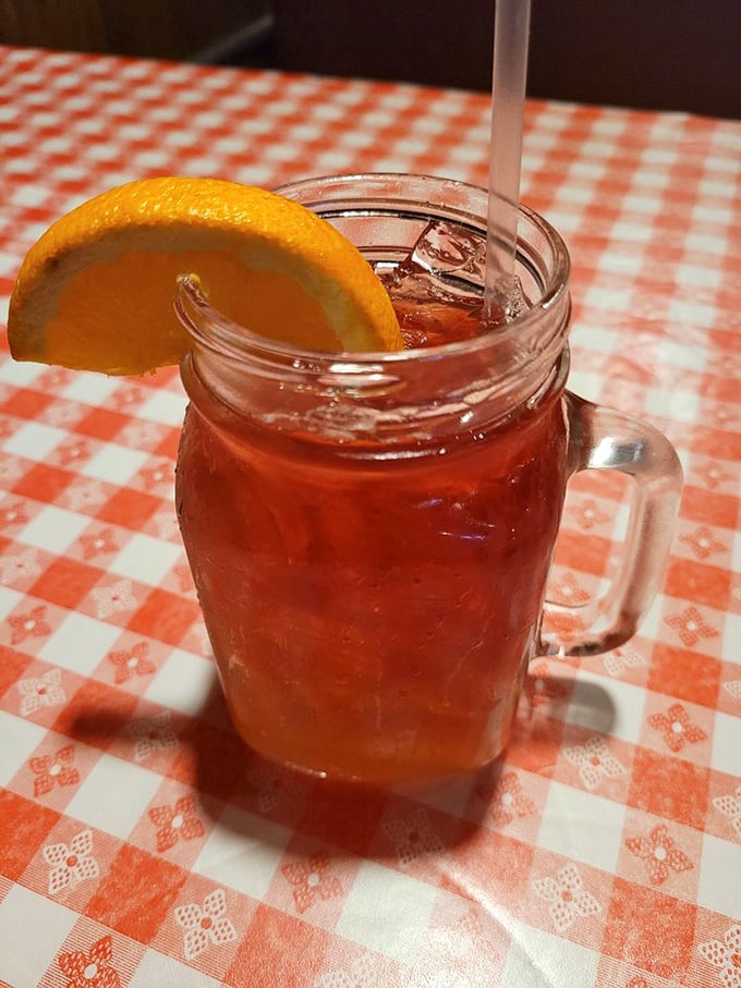 Sweet tea served in a mason jar with an orange slice &ndash; because sometimes the perfect sidekick to fried chicken comes in liquid form.