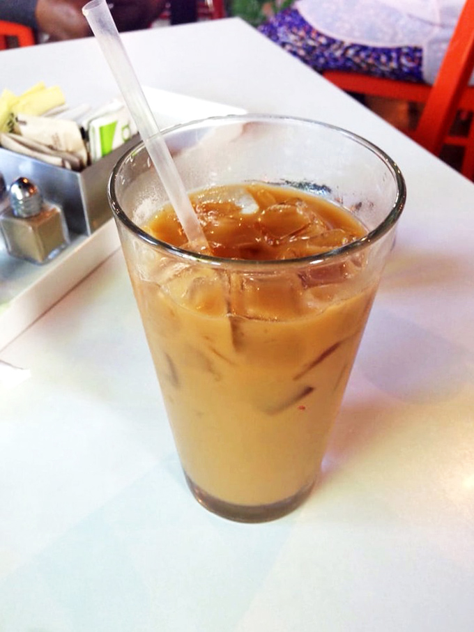 Iced coffee so perfectly amber it could be mistaken for liquid gold. The ideal companion for navigating a menu of morning delights.