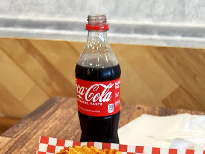The classic Coca-Cola bottle stands ready for duty. When your mouth feels like you've swallowed the sun, this isn't just a drink&mdash;it's salvation.