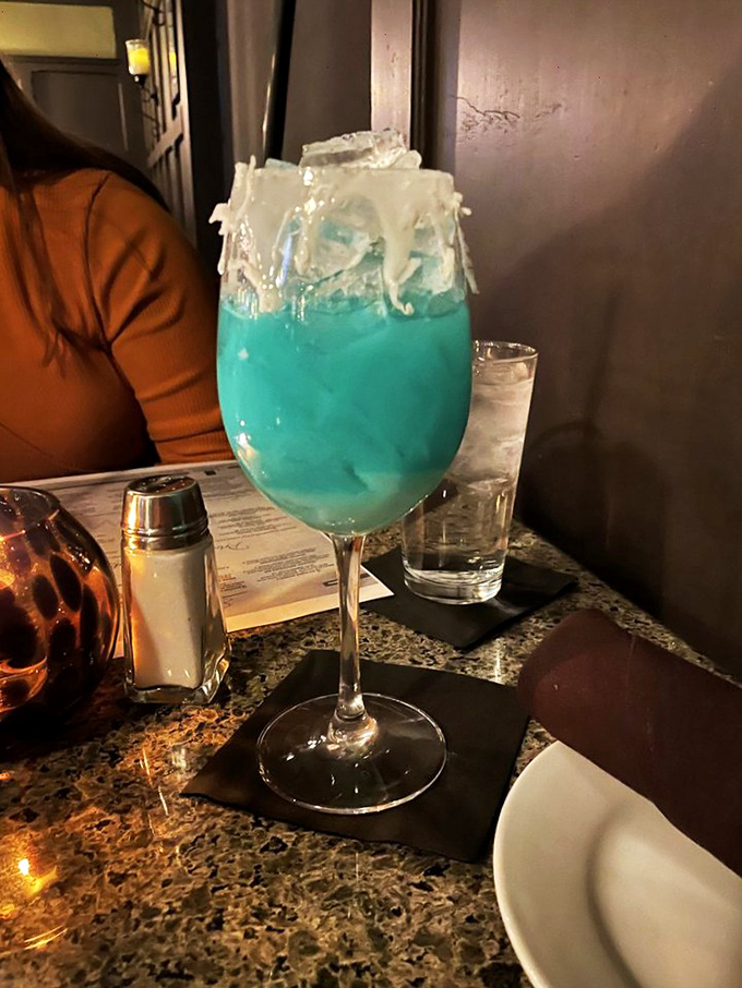 This electric blue cocktail isn't just a drink, it's a conversation piece with a license to thrill. The white chocolate rim adds a plot twist.