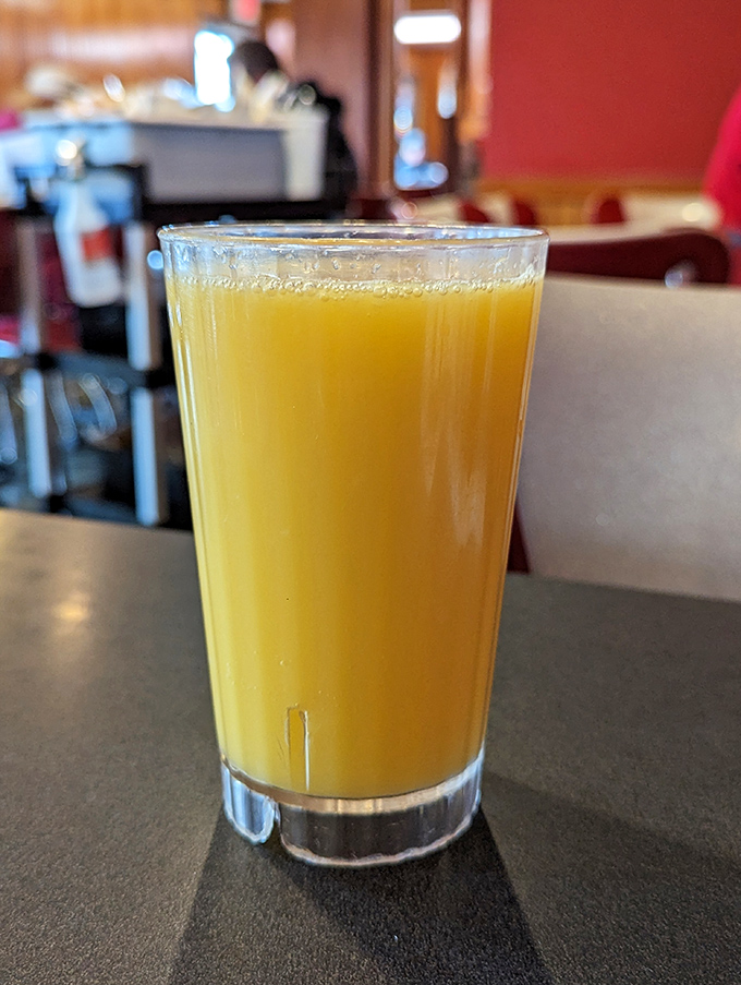 Fresh orange juice in a no-nonsense glass—because sometimes you need vitamin C to balance out all that pie. Health food, Hoosier-style.