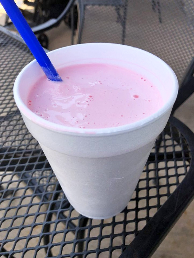 The strawberry shake arrives in its foam throne, a pink antidote to Kansas summer heat that makes you feel eight years old again.