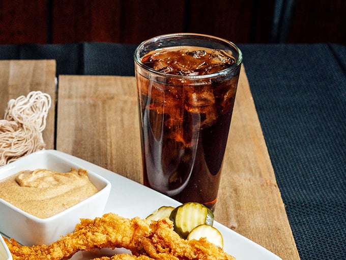 That tall, sweating glass of cola alongside house-made tartar sauce is the unsung hero of every great fish meal.