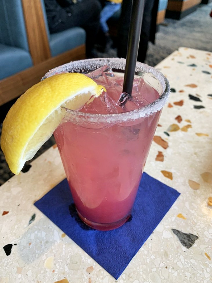 This isn't just a cocktail&mdash;it's a sunset in a glass, complete with sugar-rimmed drama and a lemon wedge trying to steal the show.