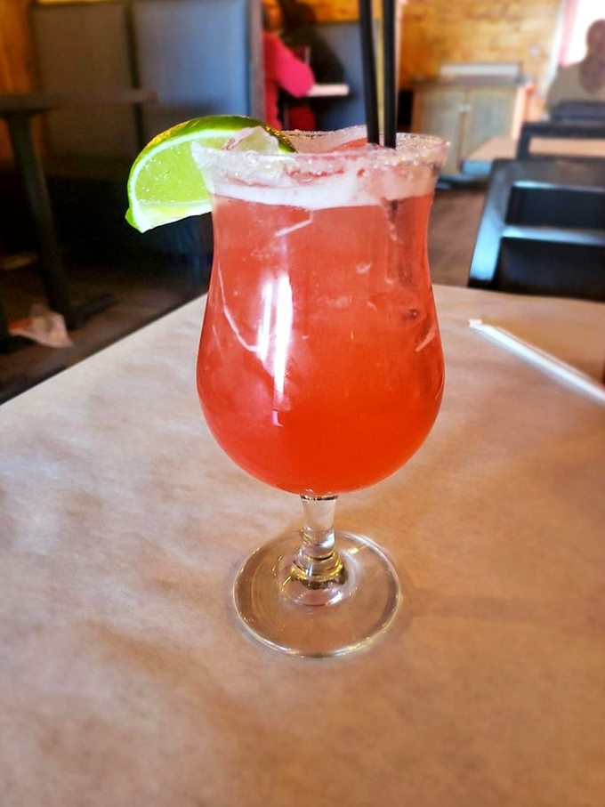 This cocktail isn't just a drink&mdash;it's a sunset in a glass with a lime smile, ready to make your seafood feast even more memorable.