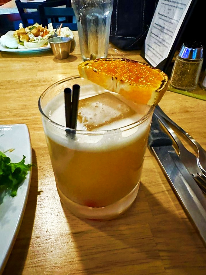 This handcrafted cocktail, garnished with charred citrus, offers the perfect prelude to the carnivorous delights that await at your table.