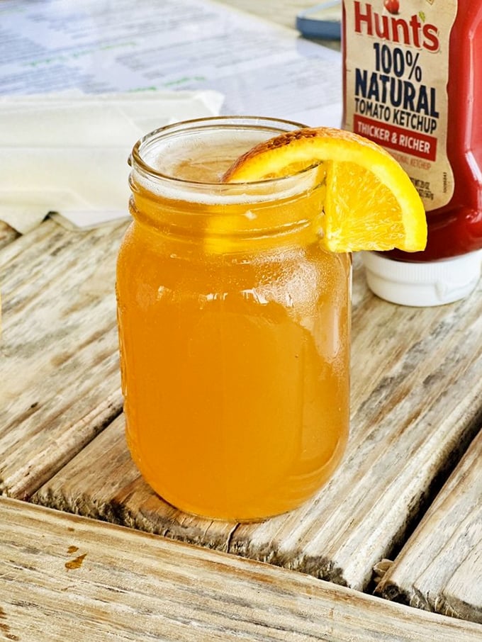 Sweet tea in a mason jar with an orange slice&mdash;the unofficial state beverage of "y'all sit a spell" hospitality.