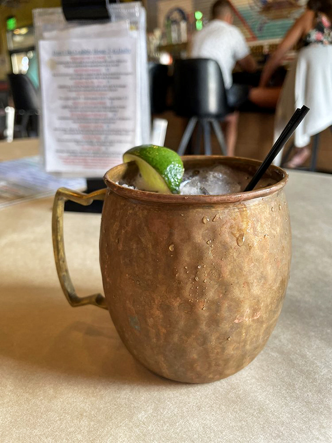 The Moscow Mule's copper mug isn't just for show—it's keeping your drink properly chilled while you contemplate your next seafood conquest.