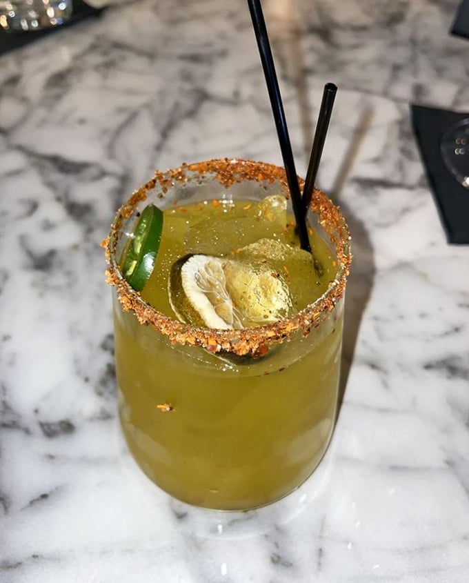 This cocktail isn't just a drink; it's a vacation in a glass. That tajin rim offers a spicy introduction to the refreshing adventure within.