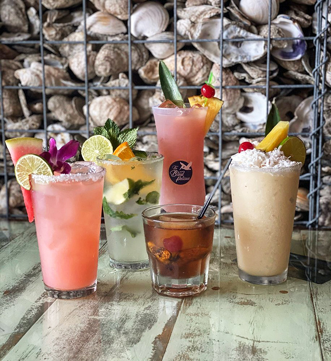 Cocktail artistry that belongs in MoMA. These vibrant libations topped with tropical garnishes make happy hour feel like a Caribbean vacation.