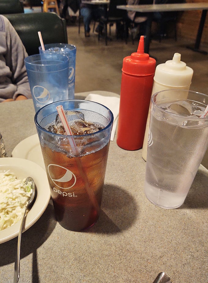 Sweet tea and soda stand at attention alongside the essential condiment duo&mdash;the red and white squeeze bottles that complete any proper Southern table.