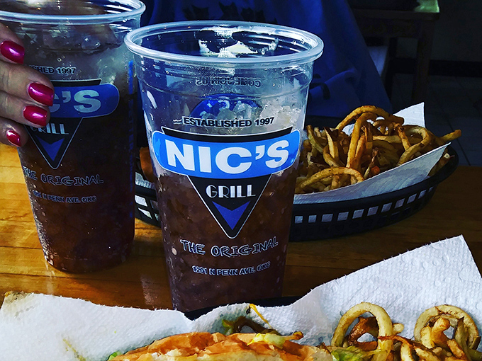 Those branded cups aren't just holding drinks&mdash;they're souvenirs from a pilgrimage that burger enthusiasts understand completely.