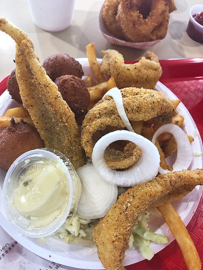 The fried seafood platter arrives like a golden treasure chest. Those perfectly breaded morsels might be hundreds of miles from the ocean, but they taste like shoreline bliss.