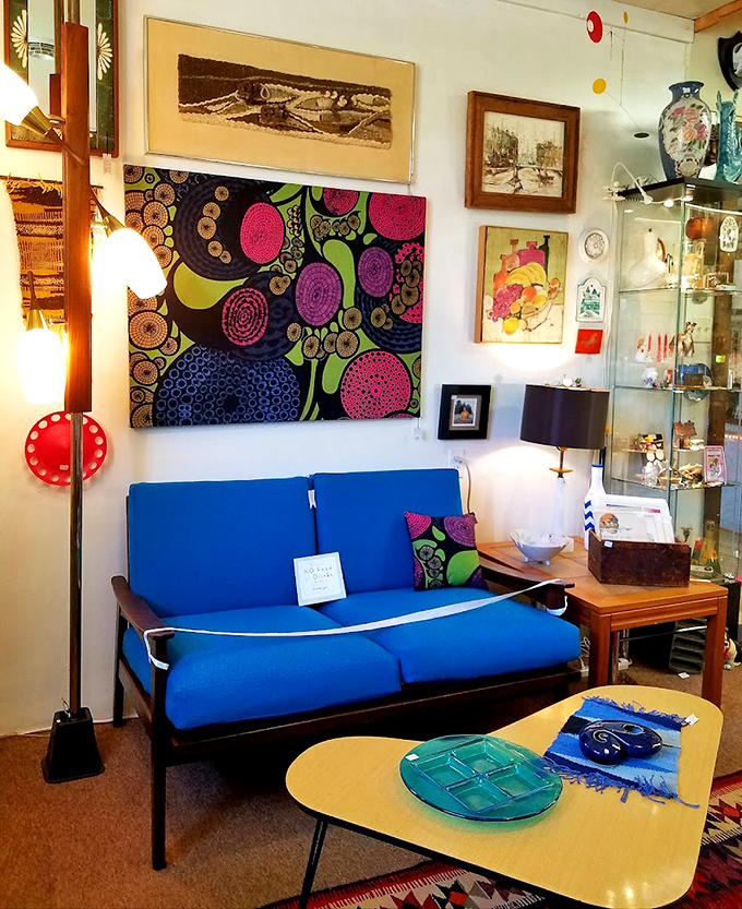 Mid-century modern meets psychedelic art in this living room vignette. That blue sofa has hosted conversations in someone's past&mdash;and future.
