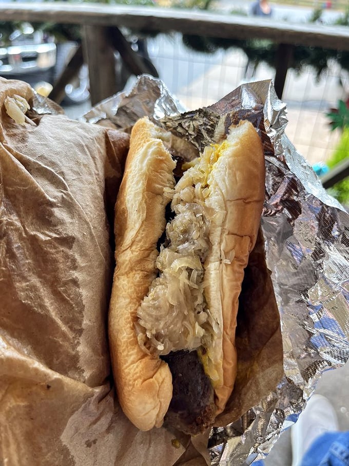 A proper sausage dog with all the fixings, enjoyed in its natural habitat—the front porch of the very place that made it. Life doesn't get much better.