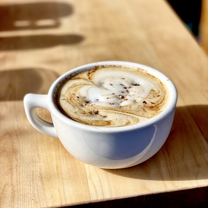 The kind of artful latte that makes you pause for appreciation before the first sip&mdash;a moment of caffeinated zen on a wooden canvas.