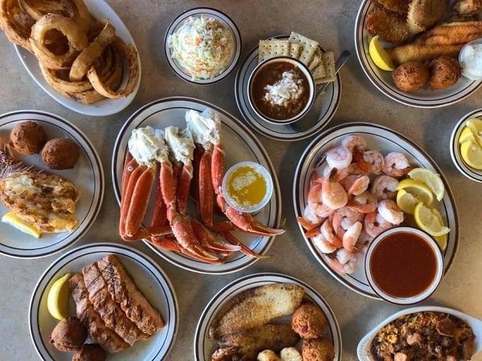 A seafood summit where everyone gets a vote&mdash;crab legs, shrimp, fish, and hushpuppies holding their delicious convention on simple white plates.