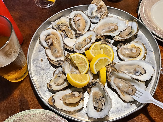 Oysters arranged like treasure on crushed ice with lemon lifeboats standing by. The ocean's most perfect delivery system for hot sauce.