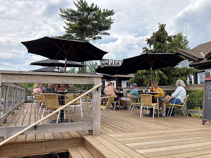 Summer's greatest gift: lakeside dining under Minnesota blue skies. Those umbrellas have witnessed countless "just one more bite" moments.