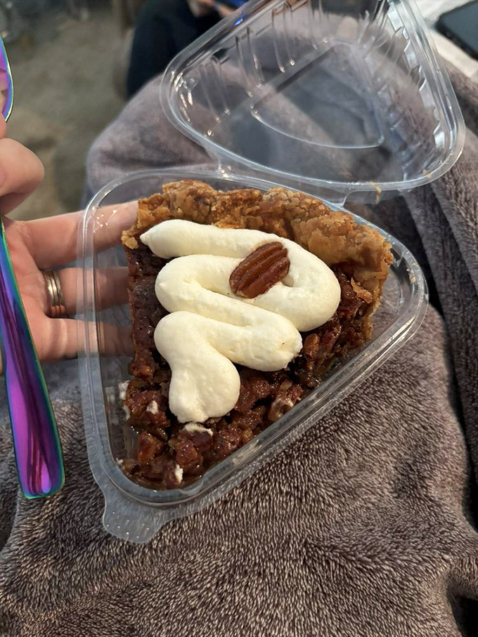 That's not just pecan pie—it's therapy in a to-go container, complete with whipped cream and a pecan on top for good measure.