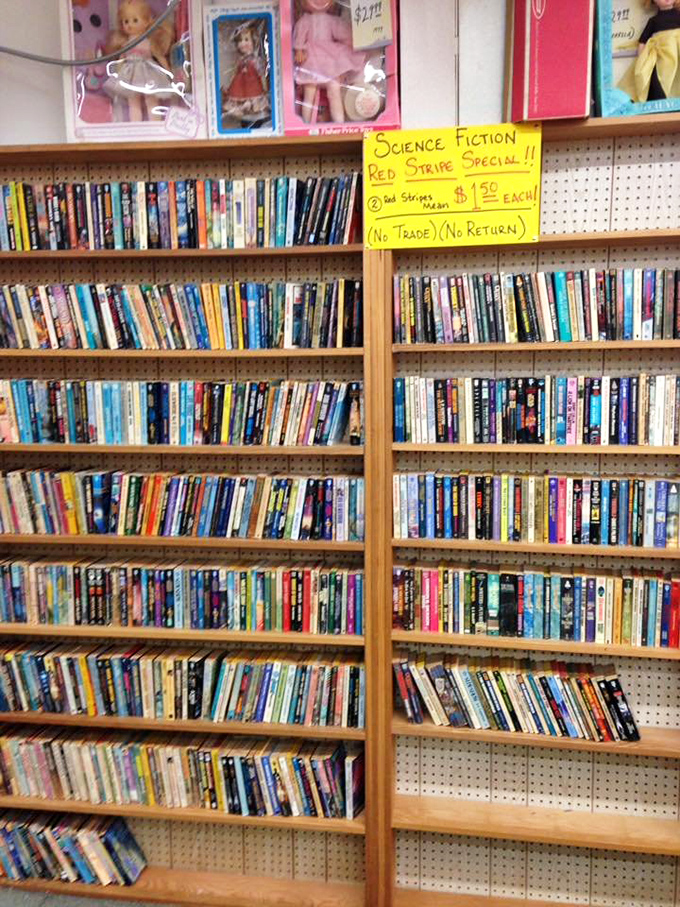 Science fiction shelves marked by the universal sign of deals: a handwritten yellow sign. Ray Bradbury would approve of this analog approach.