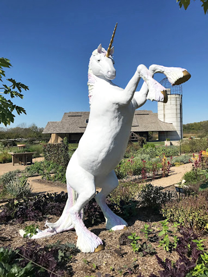 A unicorn statue rears dramatically, bringing whimsical fantasy to the edible landscape—proof that gardens needn't take themselves too seriously.