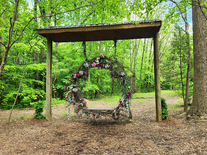 Romance hangs in the air (literally) with this flower-adorned swing that begs for Instagram moments and whispered conversations.