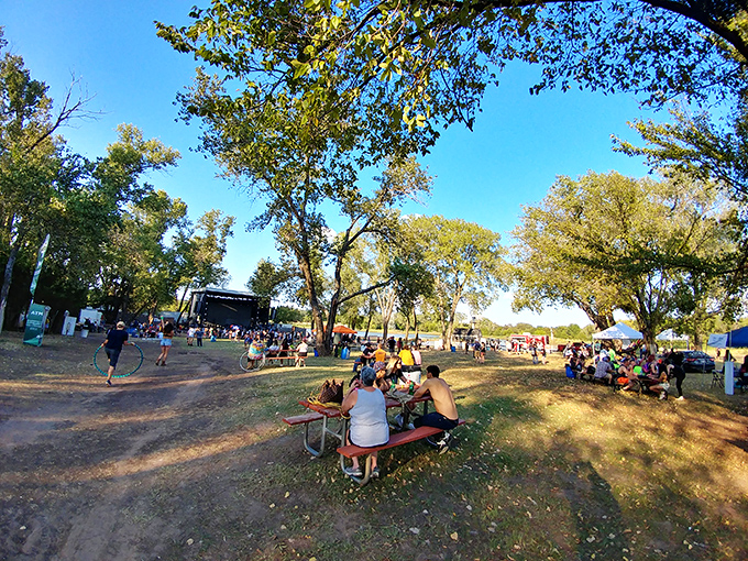 Summer in Oklahoma distilled to its essence. Picnic tables, shade trees, and the distant promise of cooling waters create the perfect escape.