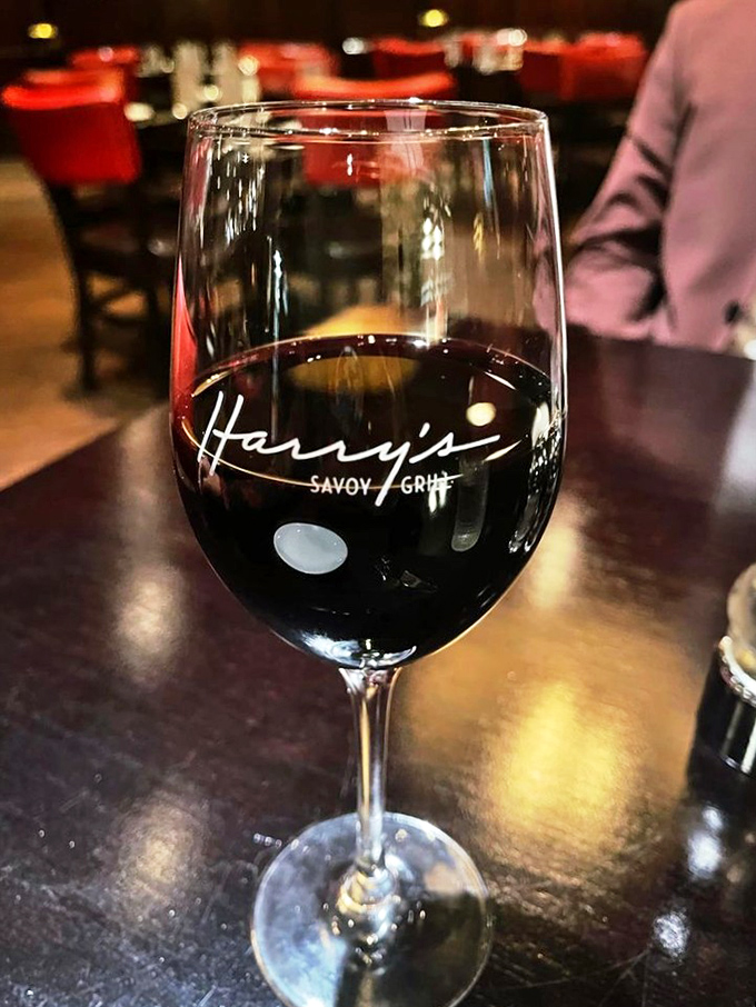 Wine this inviting deserves its own area code. Harry's branded glass reminds you exactly where this moment of grape-based bliss is happening.