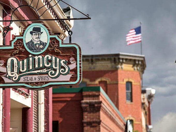 Quincy's vintage sign hangs like a treasure map marker. X marks the spot for steak gold in historic Leadville.