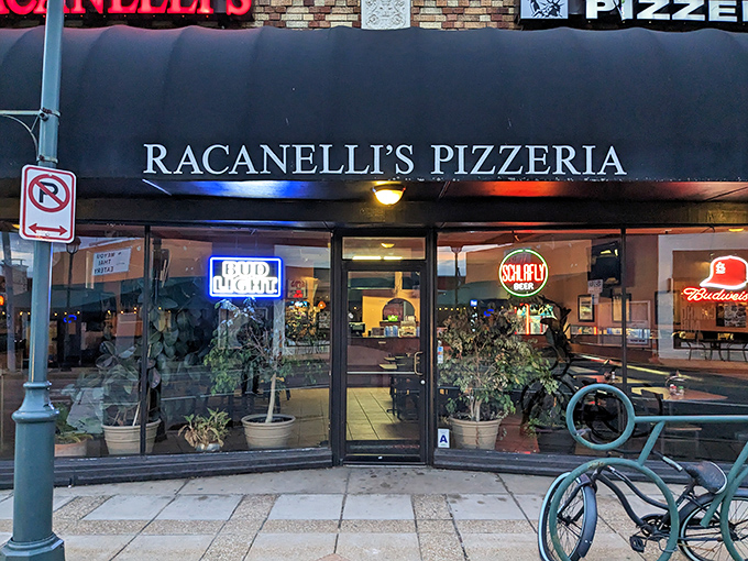 Potted plants outside, pizza perfection inside. Racanelli's black awning frames the window to a world where Missouri and Manhattan deliciously collide.