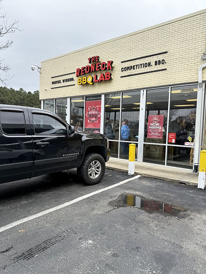 White brick, glass storefront, and a name that tells you these folks bring both humor and serious skill to their craft.
