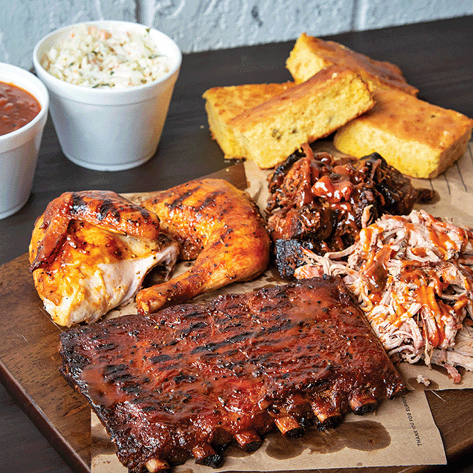 A barbecue board that belongs in the Louvre&mdash;golden cornbread, glistening ribs, and pulled pork arranged like edible art.