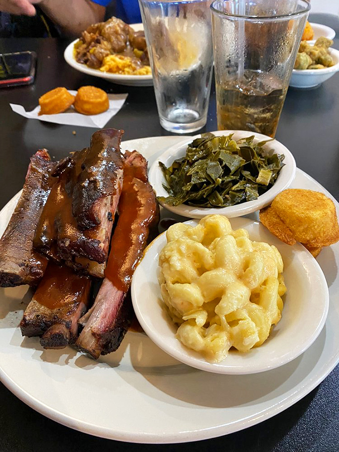 BBQ ribs glistening with sauce alongside the usual suspects&mdash;mac and cheese and collard greens. The kind of meal that demands both napkins and a post-feast nap.