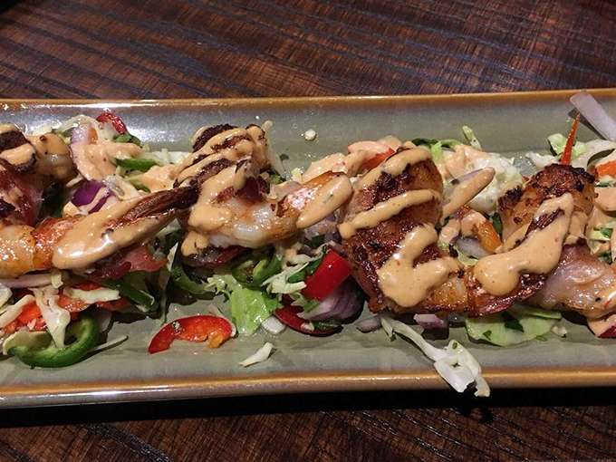 Bacon-wrapped shrimp drizzled with sauce&mdash;because sometimes land and sea need to get together and create a little culinary magic.