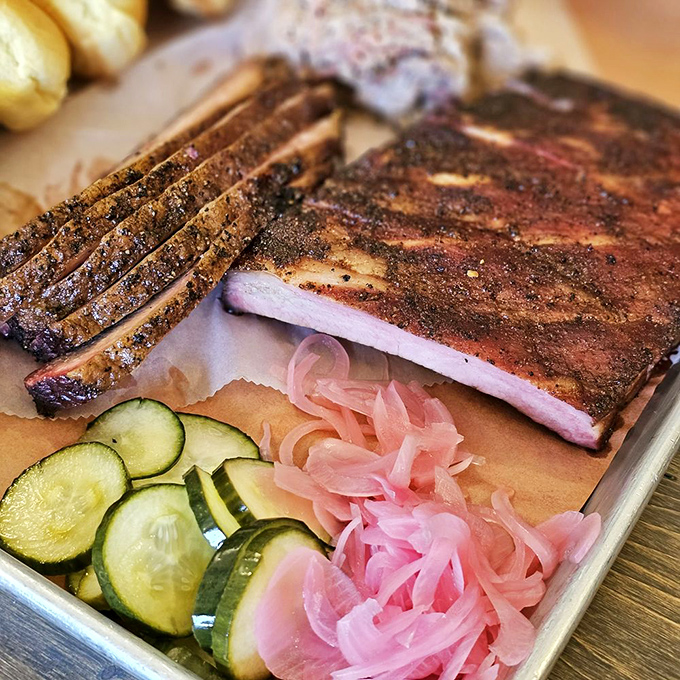 Meat arranged with the precision of a Renaissance painting. The pickle garnish is the Mona Lisa's smile.