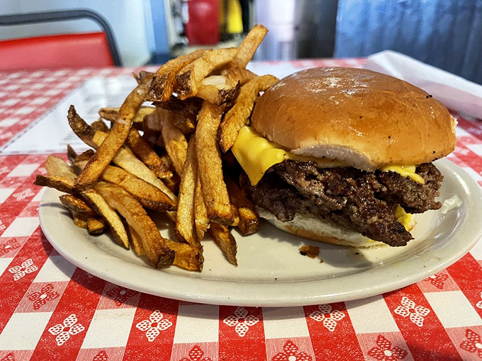 Sometimes you need a burger that looks like it graduated from the school of no-nonsense deliciousness. Those fries deserve their own fan club.