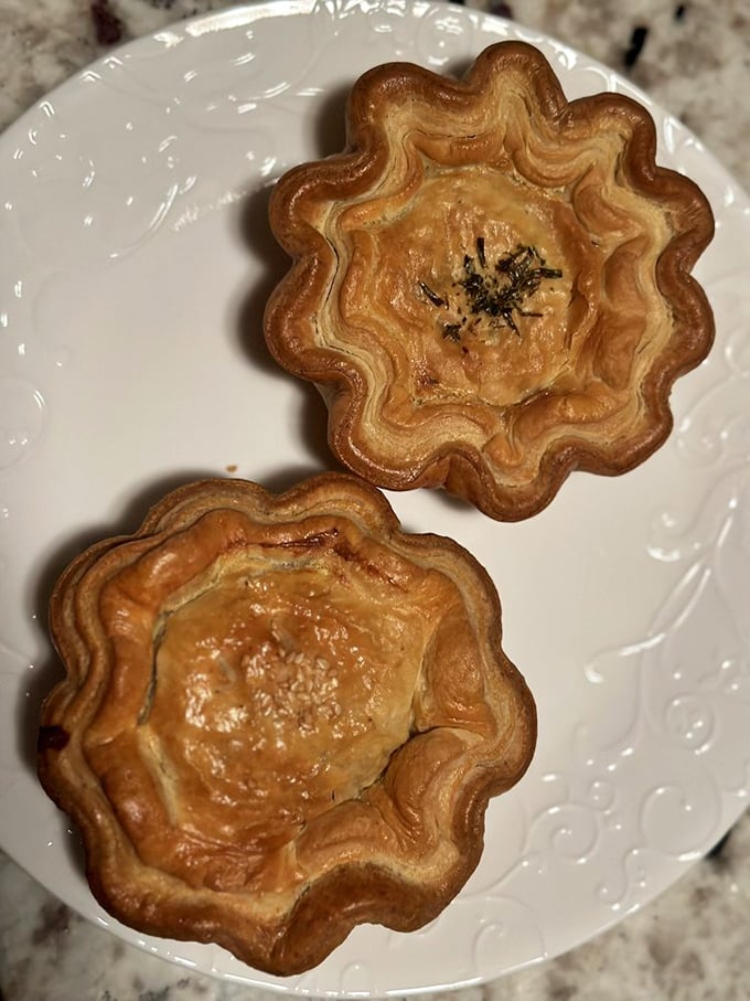 Two savory pies with their distinctive flower-shaped crimping&mdash;like edible sunbursts waiting to reveal their savory treasures within.
