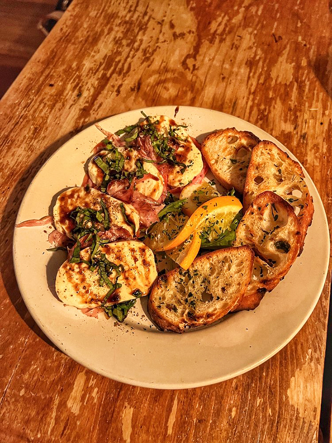 Caprese with attitude&mdash;fresh mozzarella and heirloom tomatoes having a garden party on rustic bread. Summer captured on a plate, no passport required.