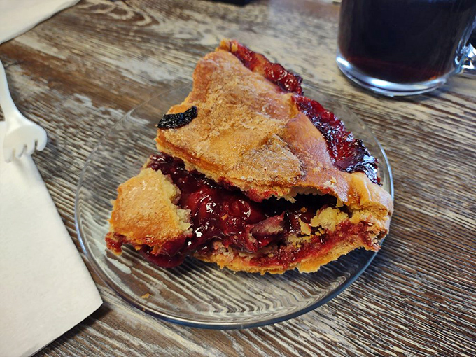 Cherry raspberry pie with that perfect crimson ooze. The fruit-to-crust ratio here would make Paul Hollywood weep with joy.