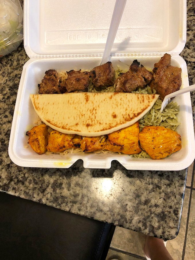 A study in contrasts: earthy lamb meets vibrant chicken tikka. The half-moon pita stands ready like a culinary ambassador.